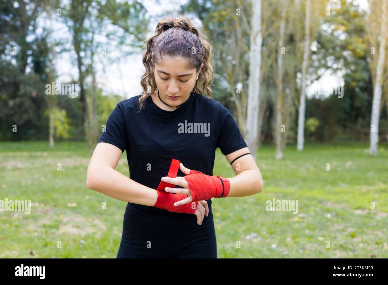 Female boxer winding wrap bandage for boxing training. Fighting sport ...