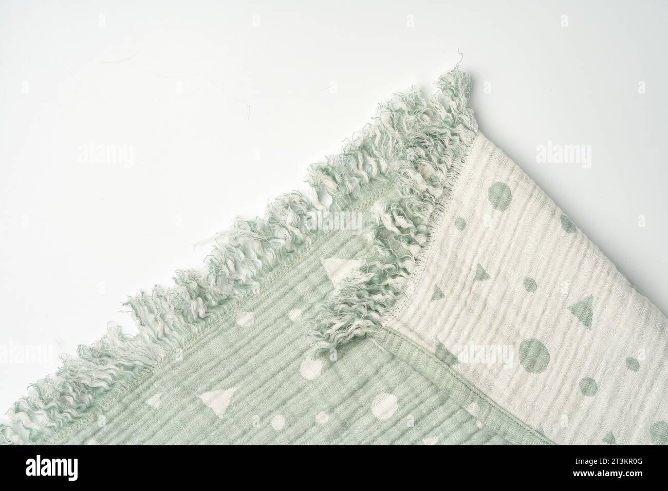 Green muslin blanket for kids on white background Stock Photo - Alamy