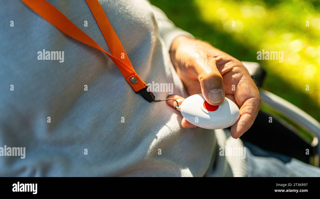 Elderly person pressing emergency Button in his Hand outside in a ...
