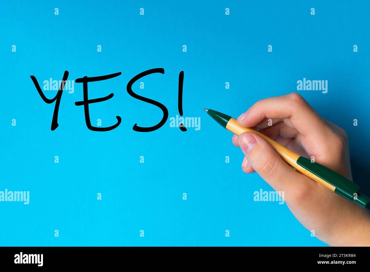 Children hand with pen write on an blue white background. Writing hand ...