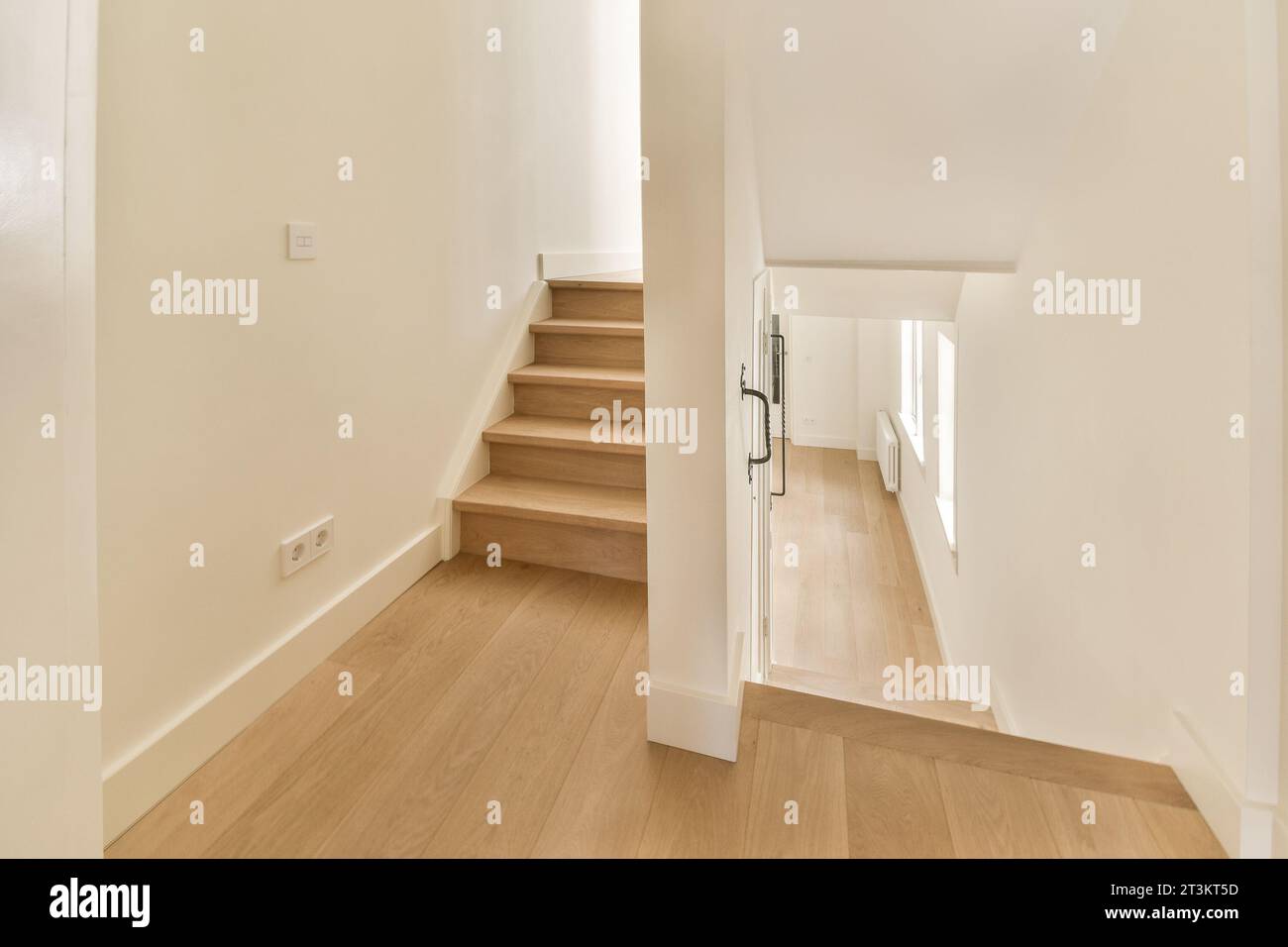 the inside of a house with wood flooring and stairs leading up to the ...