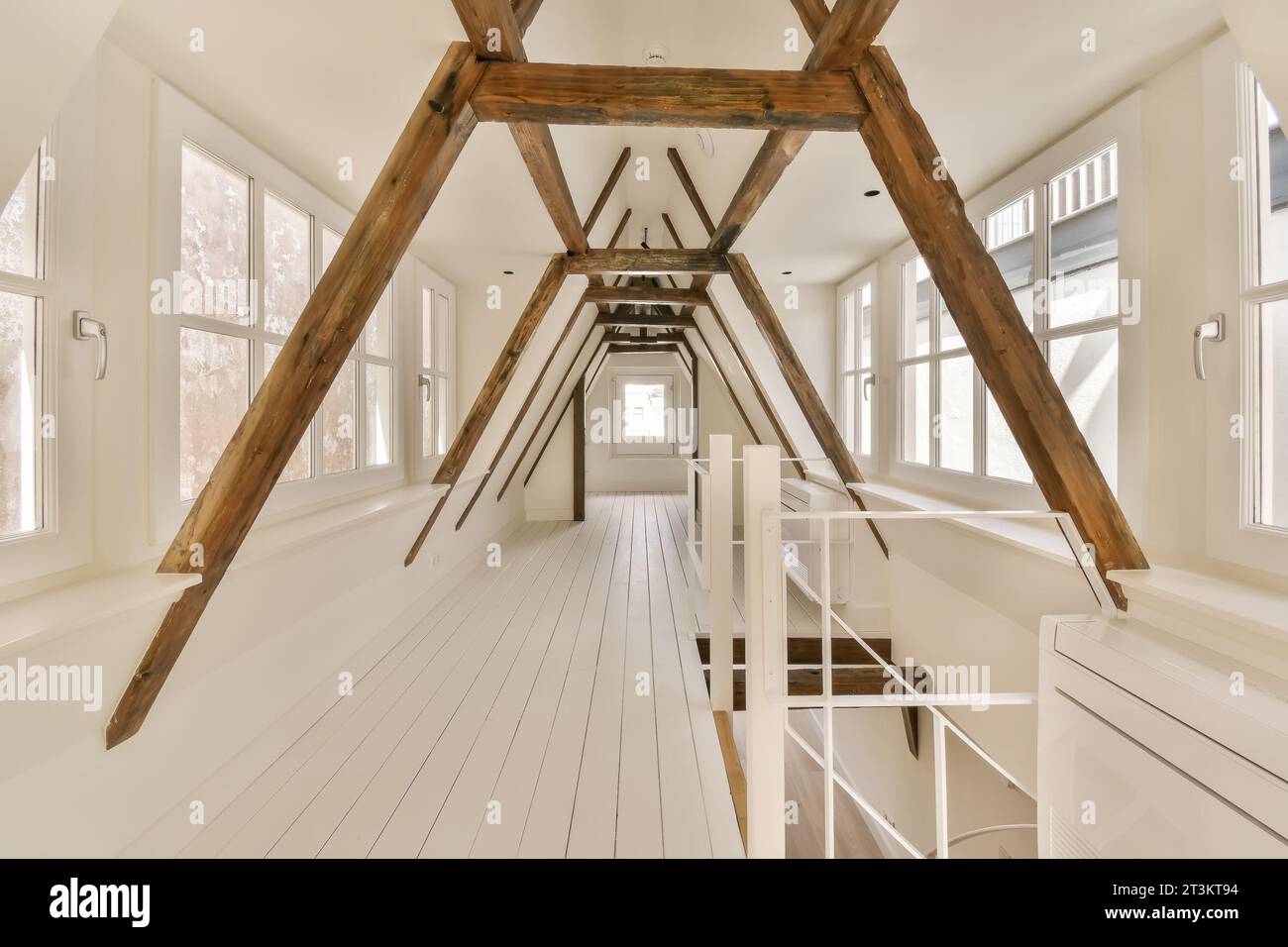 a room with white walls and wood beams on the ceiling, there is a ...