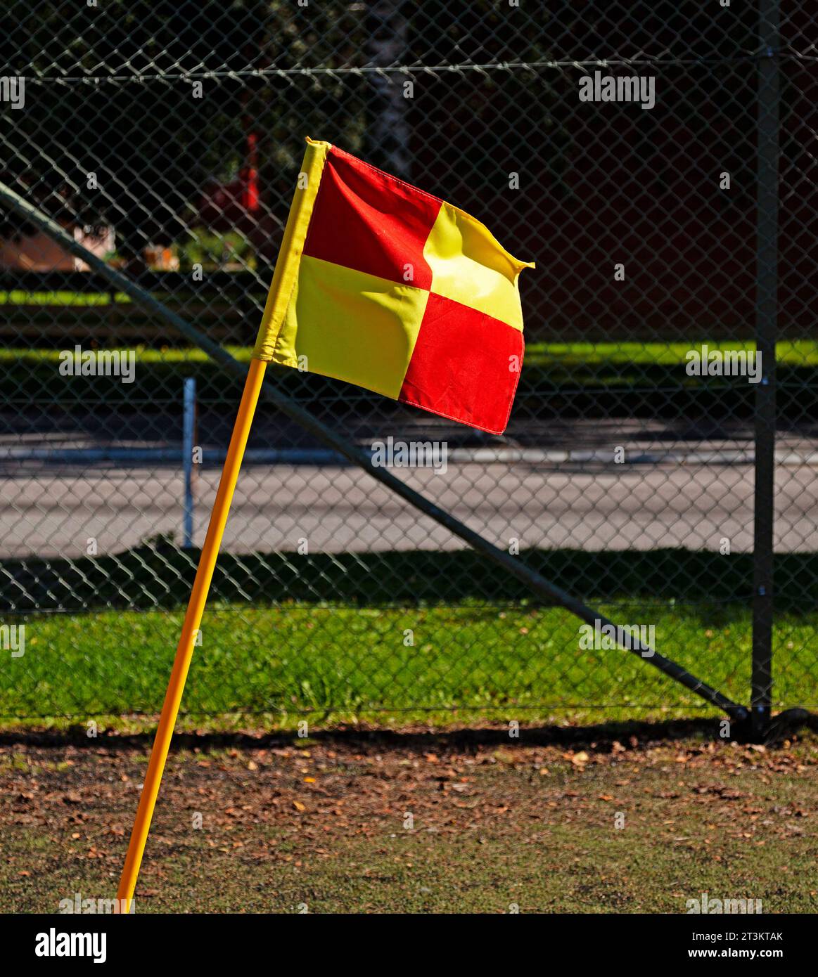 leaning corner flag on a football field red and yellow Stock Photo - Alamy