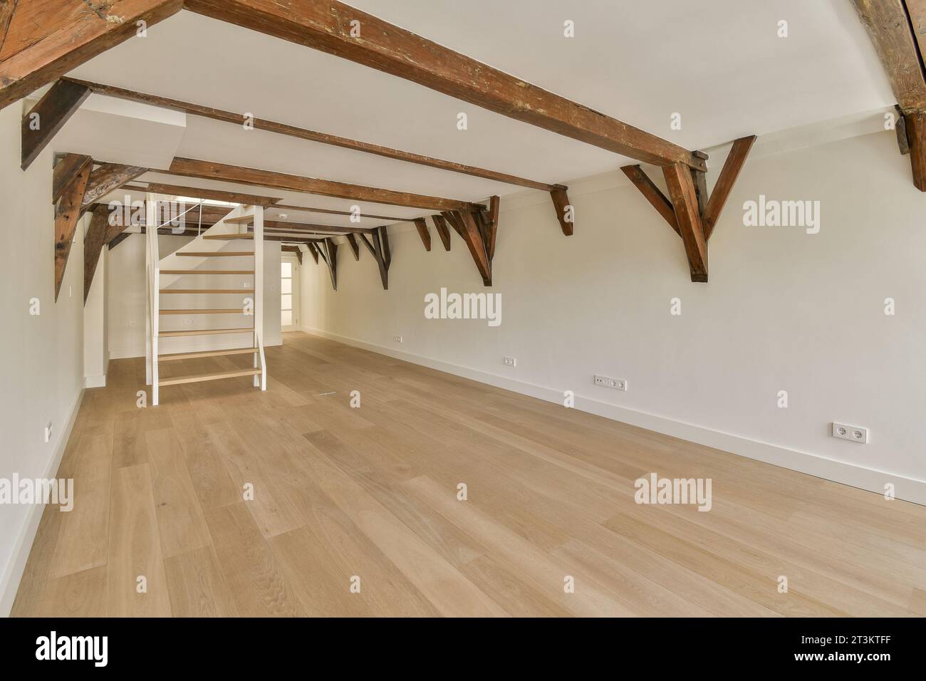 an empty room with wood flooring and exposed beams on the ceiling above ...