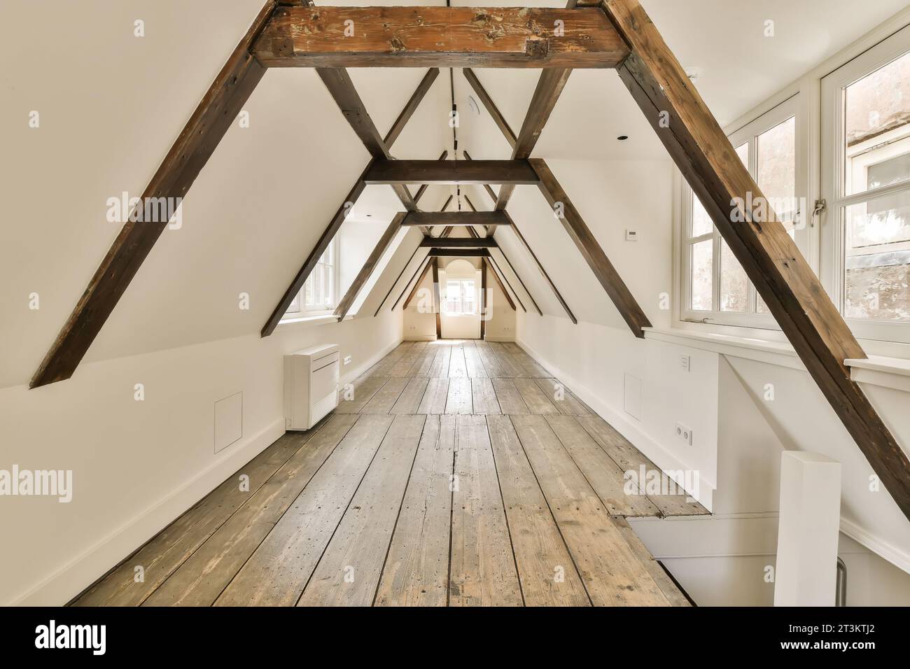 an attic with wood flooring and exposed beams on the ceiling, white ...