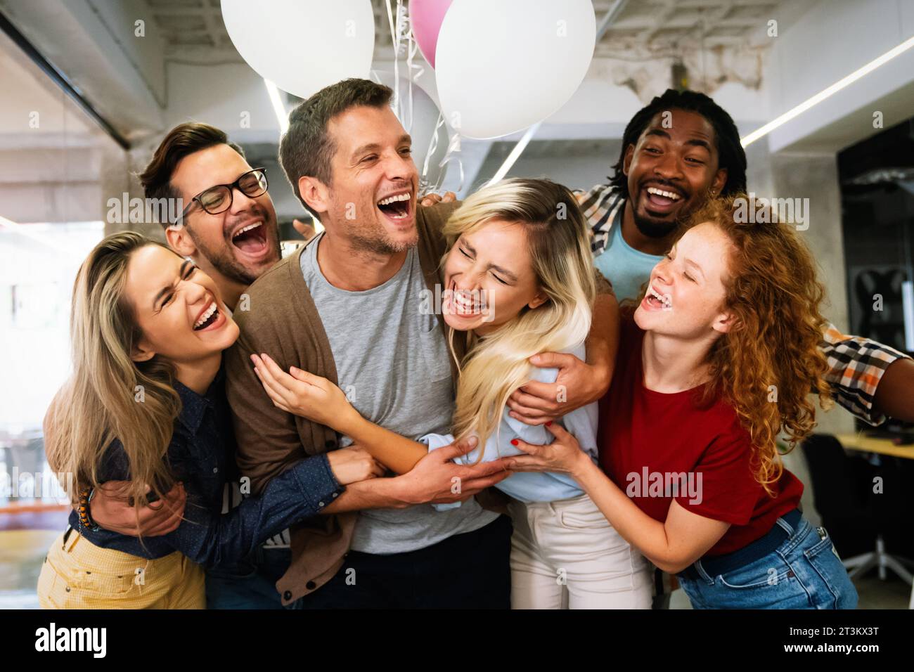 Happy business people celebrating success at company Stock Photo - Alamy
