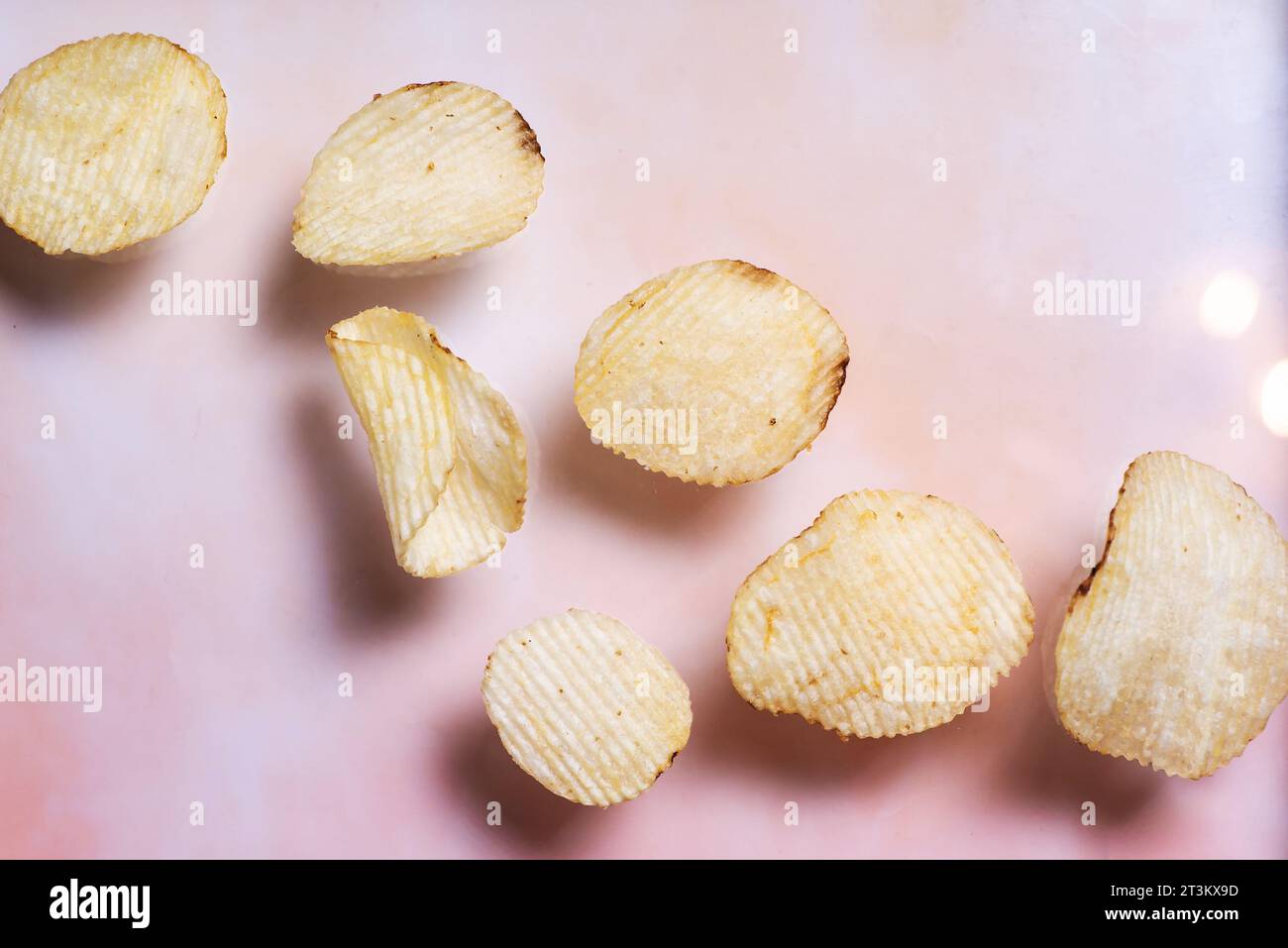 Crispy potato chips flying on a light background Stock Photo - Alamy