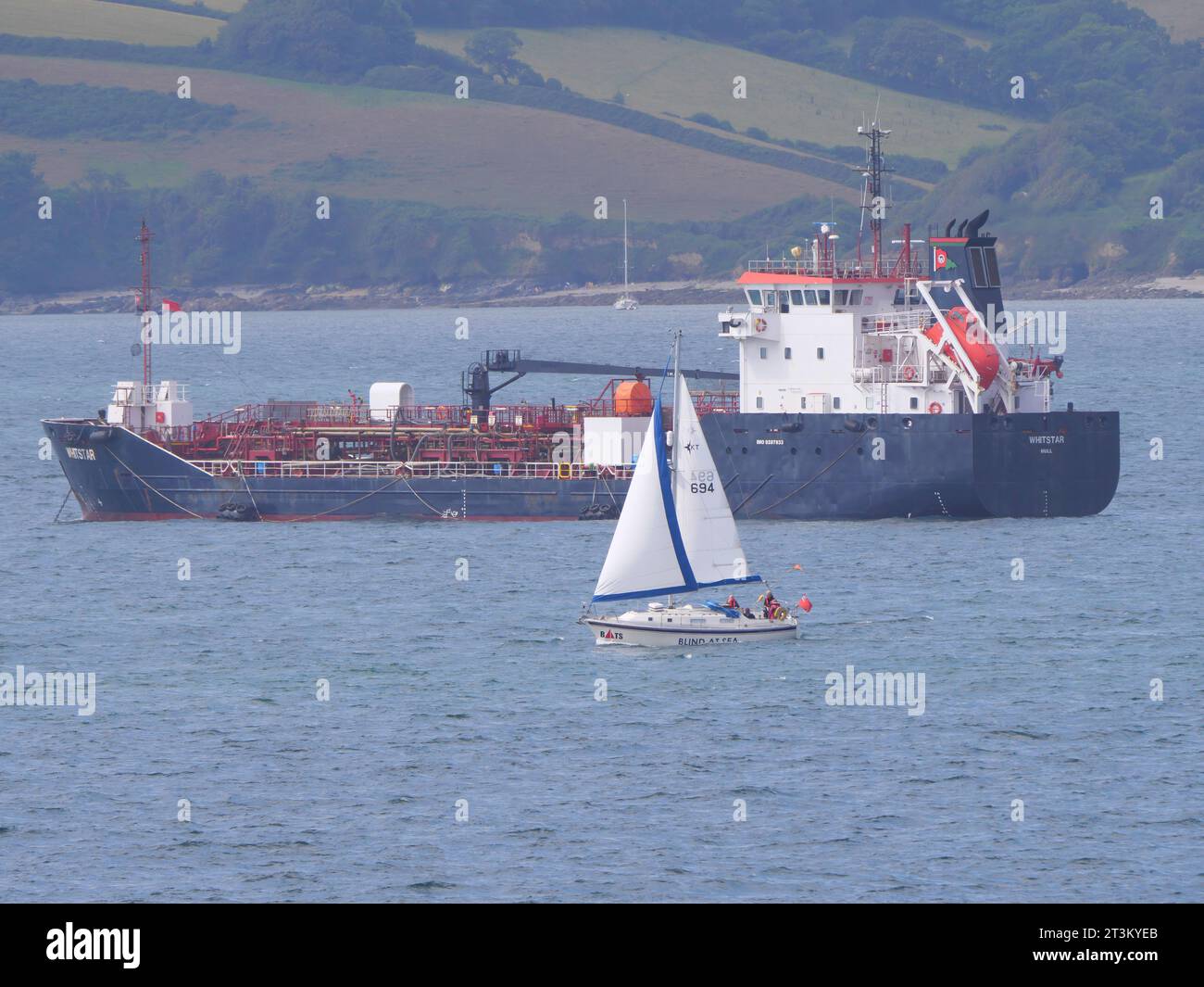 Cargo ship and small sailboat sailing side by side off Roseland ...