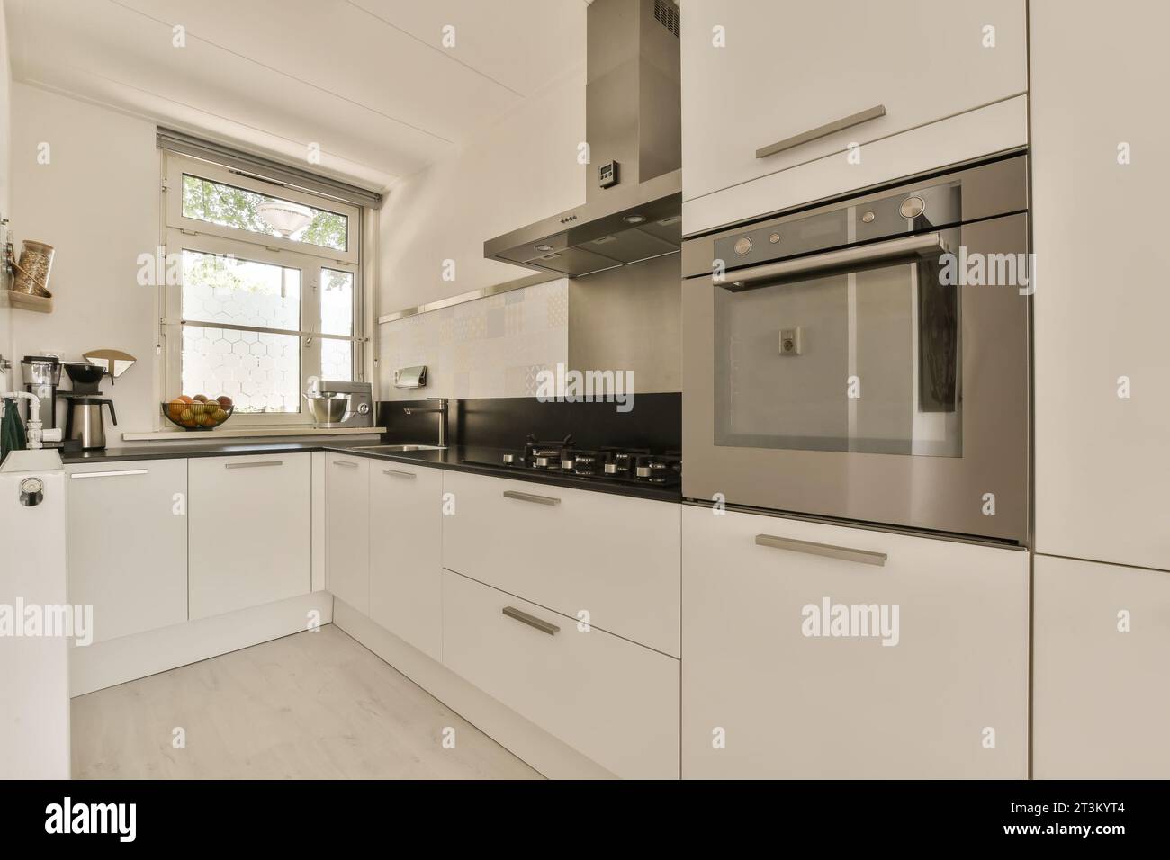 a kitchen with white cabinets and black counter tops on the top shelf ...