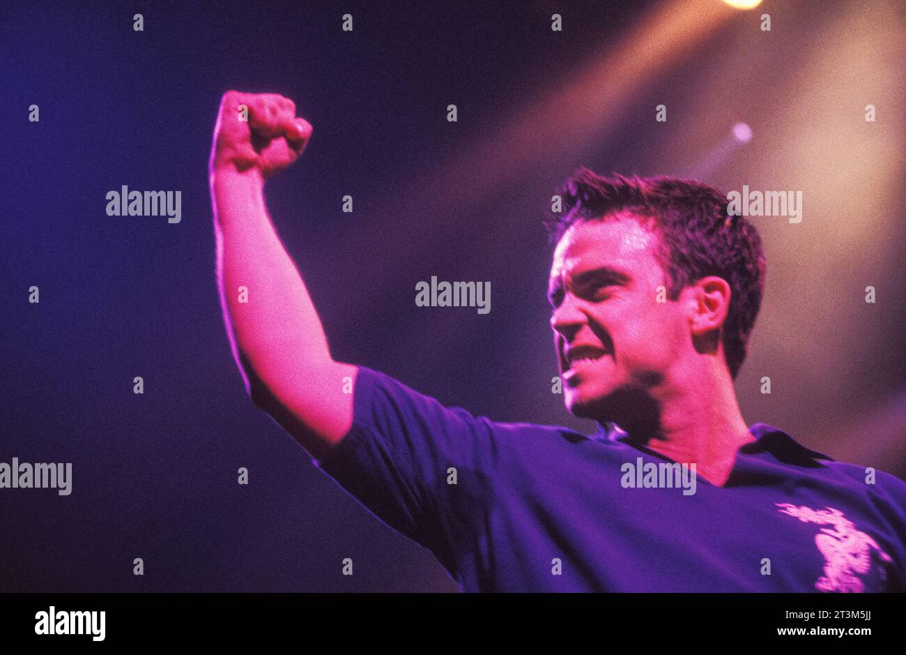 ROBBIE WILLIAMS, CARDIFF, 1999: Robbie Williams flexes his biceps on ...