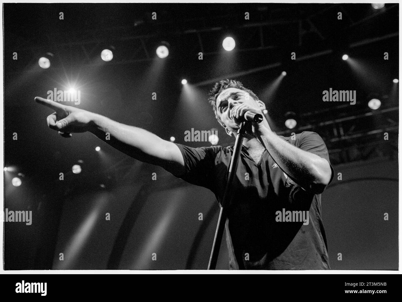ROBBIE WILLIAMS, CARDIFF, 1999: Robbie Williams points into the crowd ...