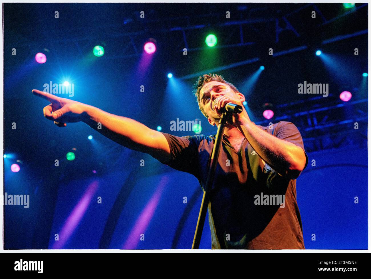 ROBBIE WILLIAMS, CARDIFF, 1999: Robbie Williams points into the crowd ...