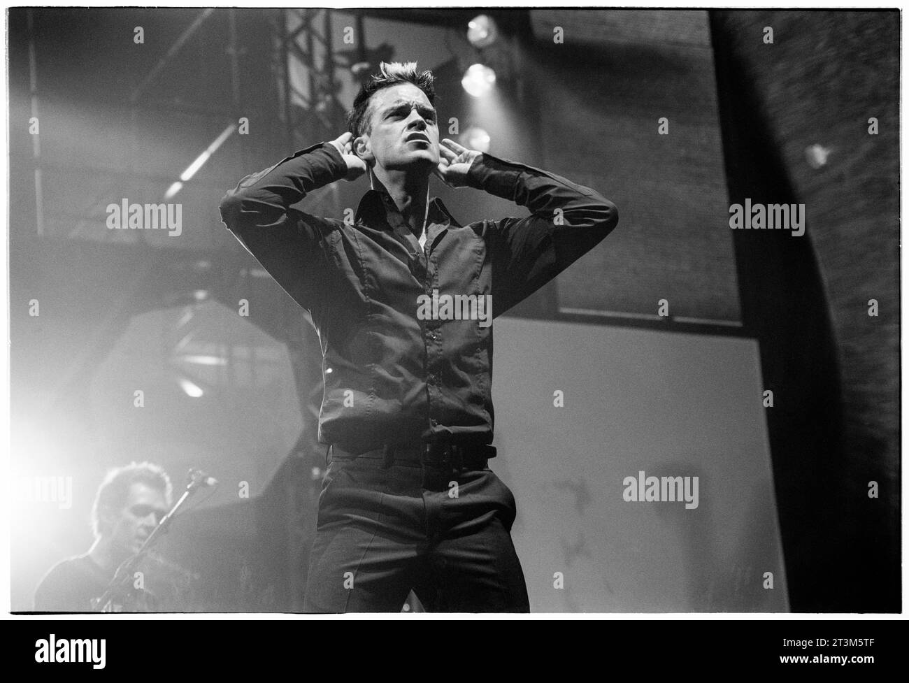 ROBBIE WILLIAMS, CARDIFF, 2001: Robbie Williams listens to the crowd ...