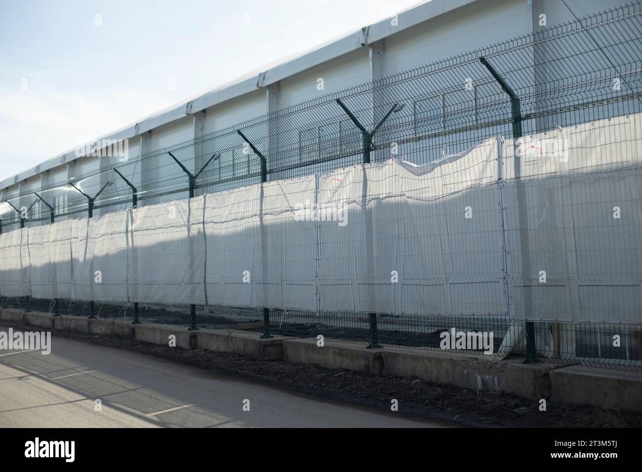 High fence around plant. Fence mesh. Steel obstacle. Private territory ...