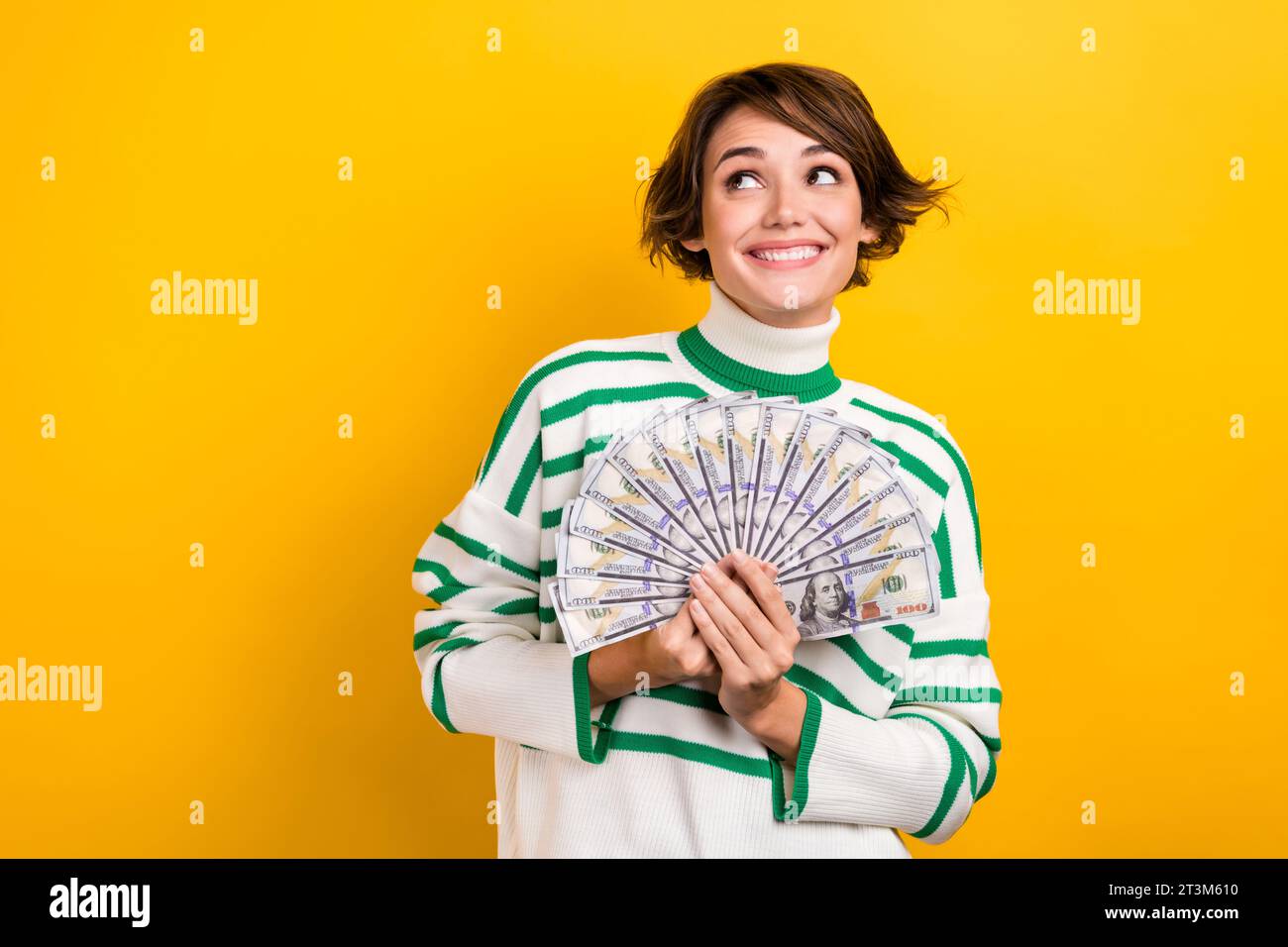 Photo of sweet dreamy lady wear striped pullover holding cash fan ...