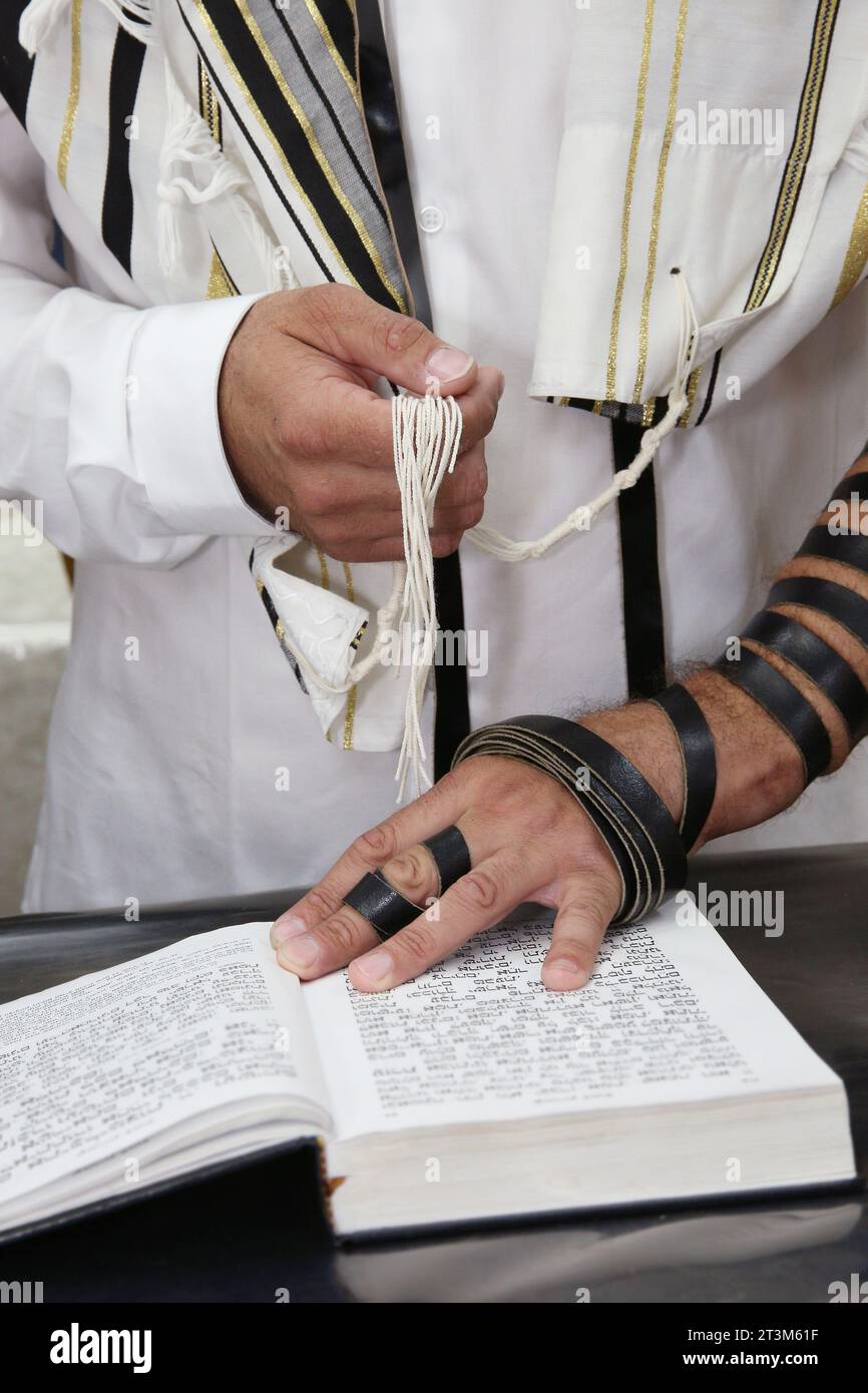 An jewish man is reading his bible and praying Stock Photo - Alamy