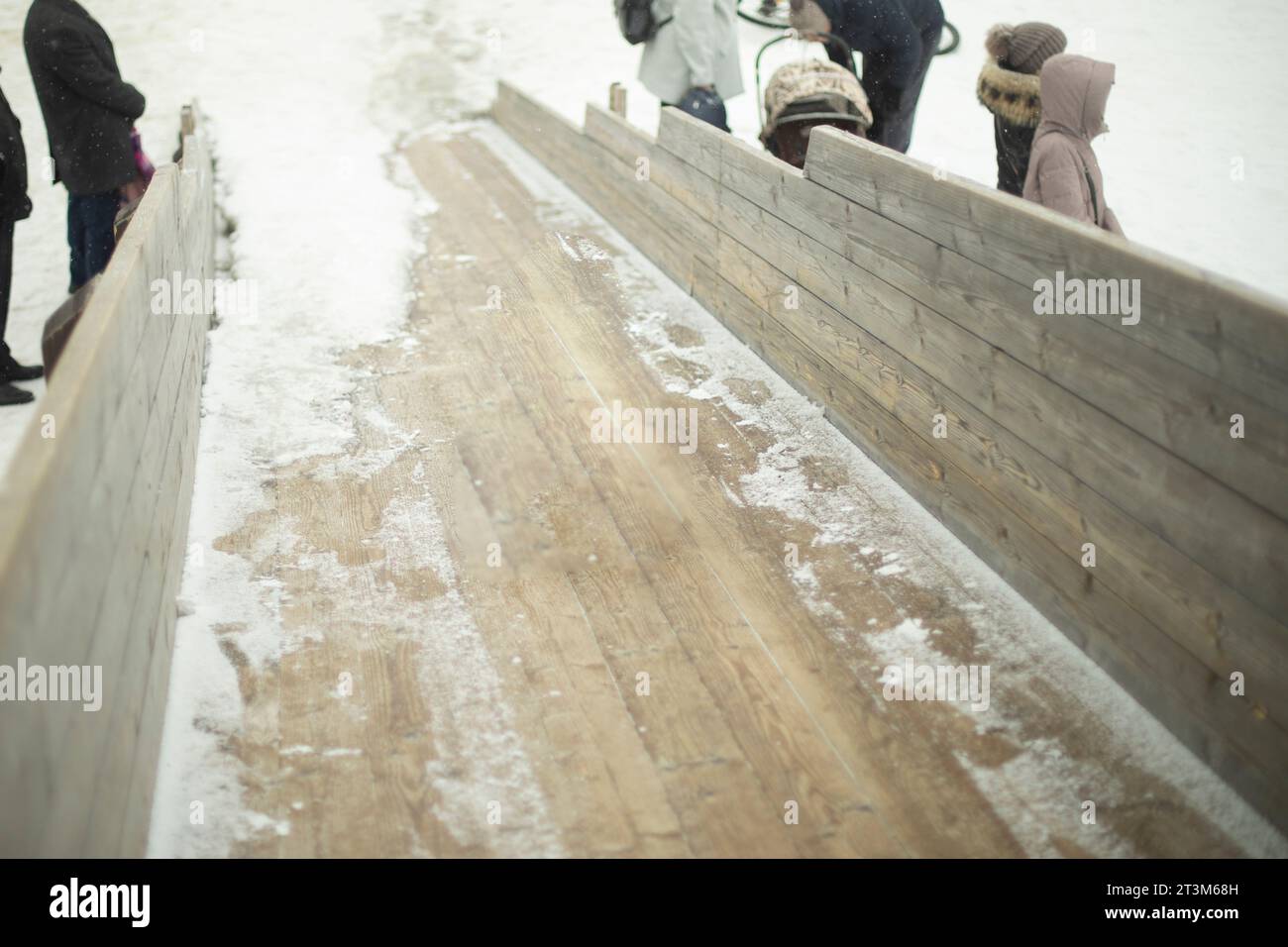 Child rolls down slide in winter. Boy on slide. Preschooler glides on ...
