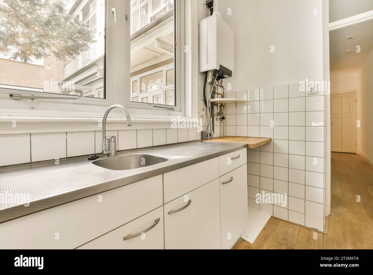 a kitchen with white cabinets and black counter tops on the counters in ...