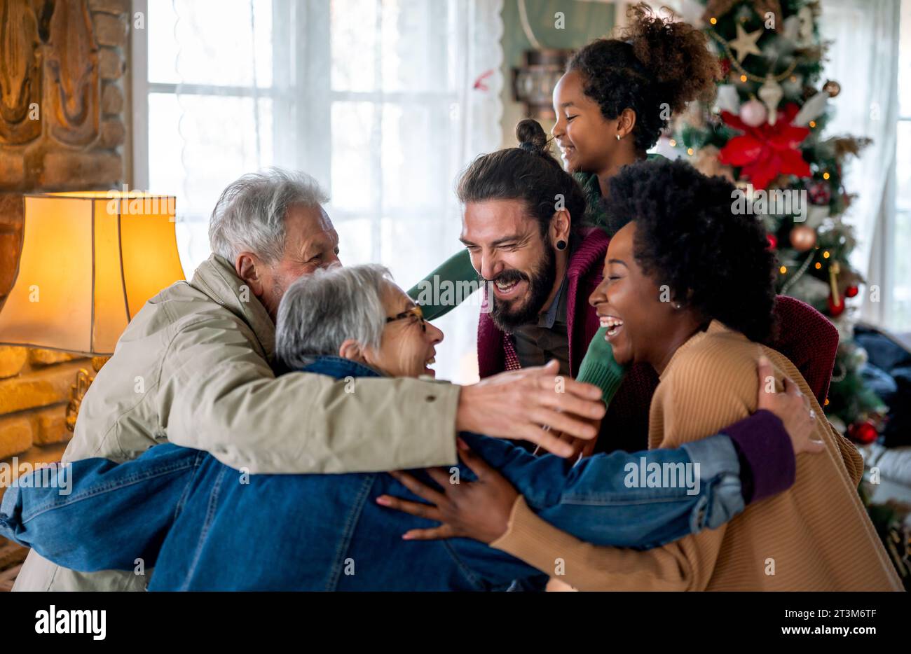 Happy multiethnic multi-generational family enjoying Christmas time ...