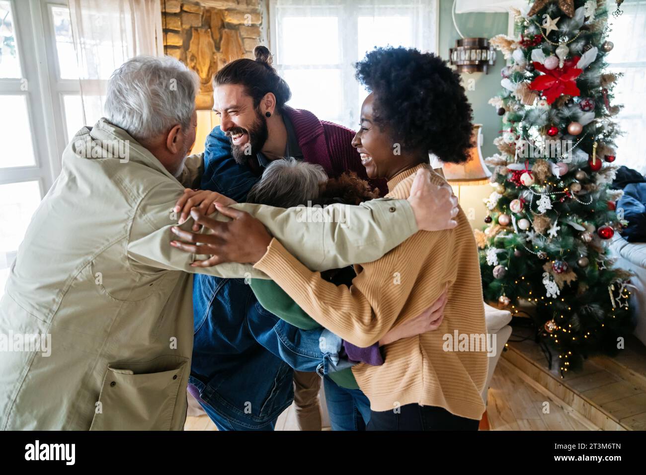 Happy multiethnic multi-generational family enjoying Christmas time ...