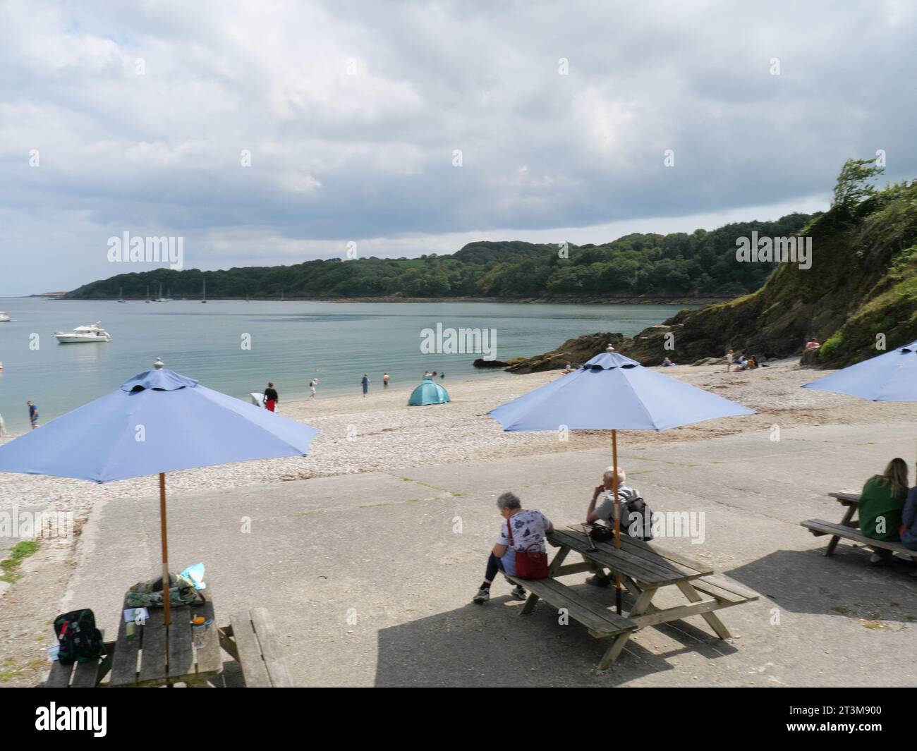Sandy beach with blue umbrellas and view of the English Channel in ...
