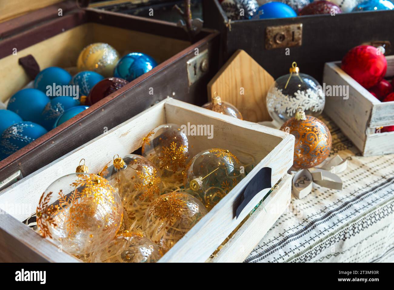 Christmas tree decorations, colorful glass balls lay in wooden boxes ...