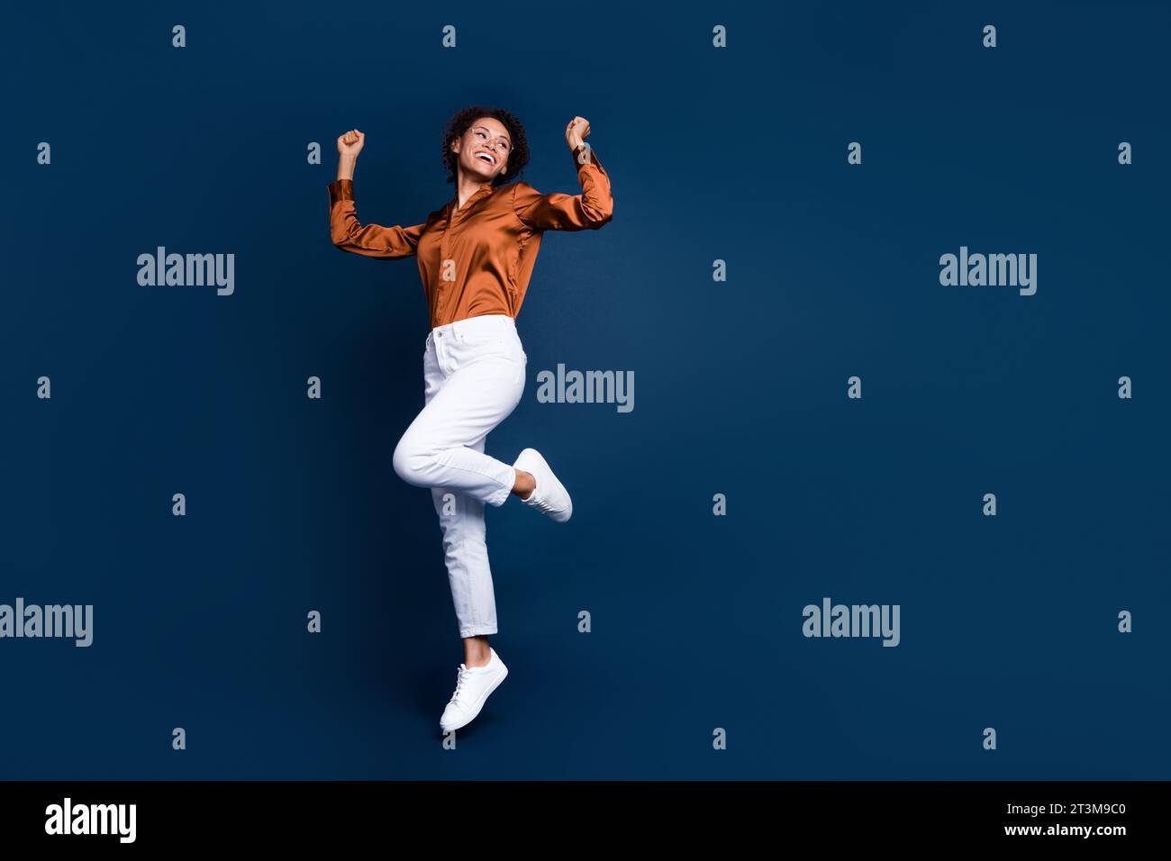 Full size photo of attractive young woman jump celebrate win dressed ...