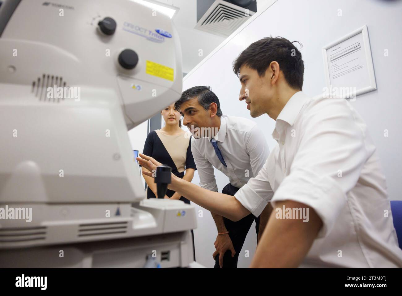 Prime Minister Rishi Sunak (centre) is shown a Retinal Scan procedure ...