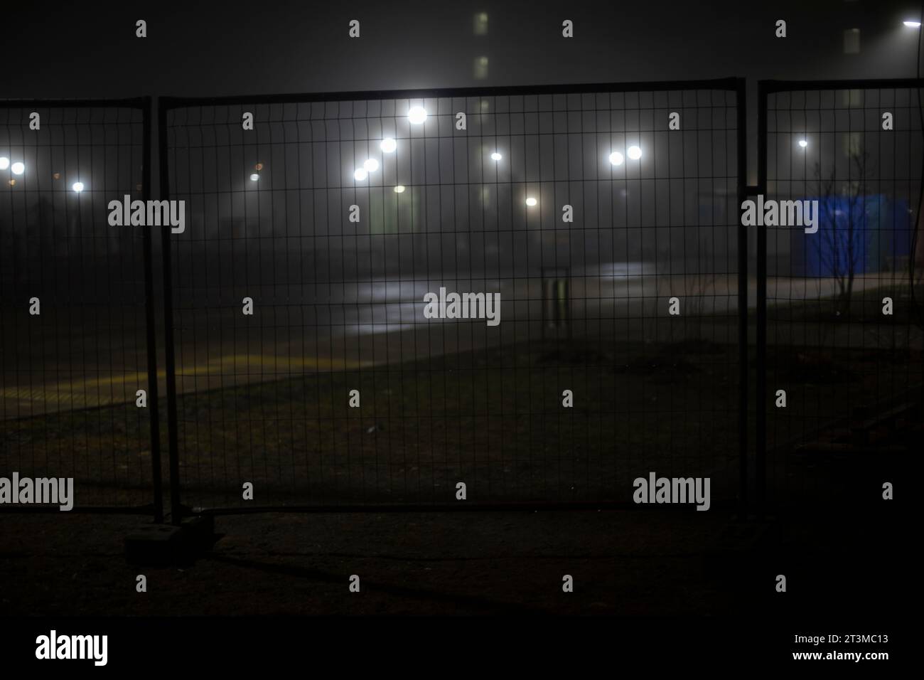 Fence at night. Closed area. City at night. Fence mesh Stock Photo - Alamy