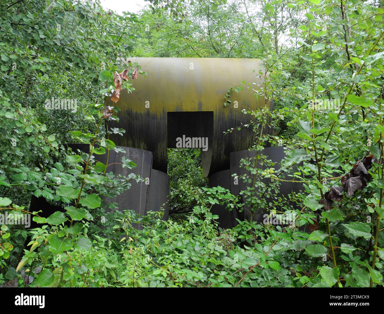 Large metal tubes are stacked to form a gate Stock Photo - Alamy