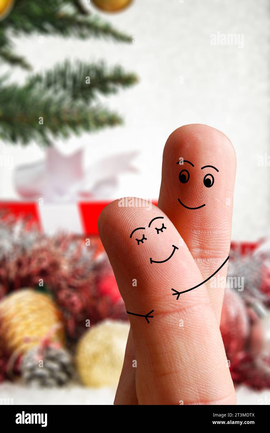 Faces of fingers hugging each other isolated on Christmas decorated ...