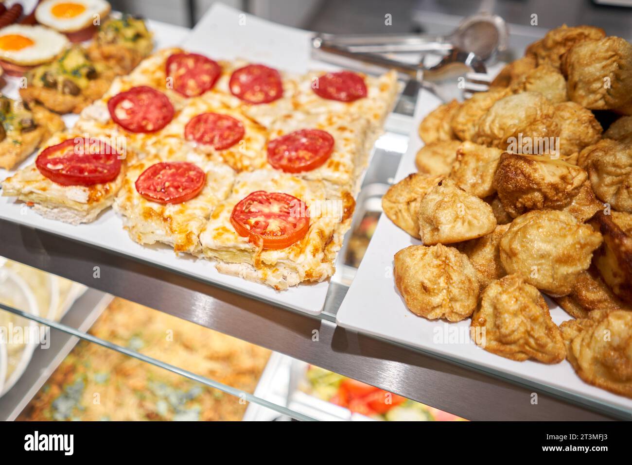 Various hot dishes . Glass Showcase in a buffet or self-service ...