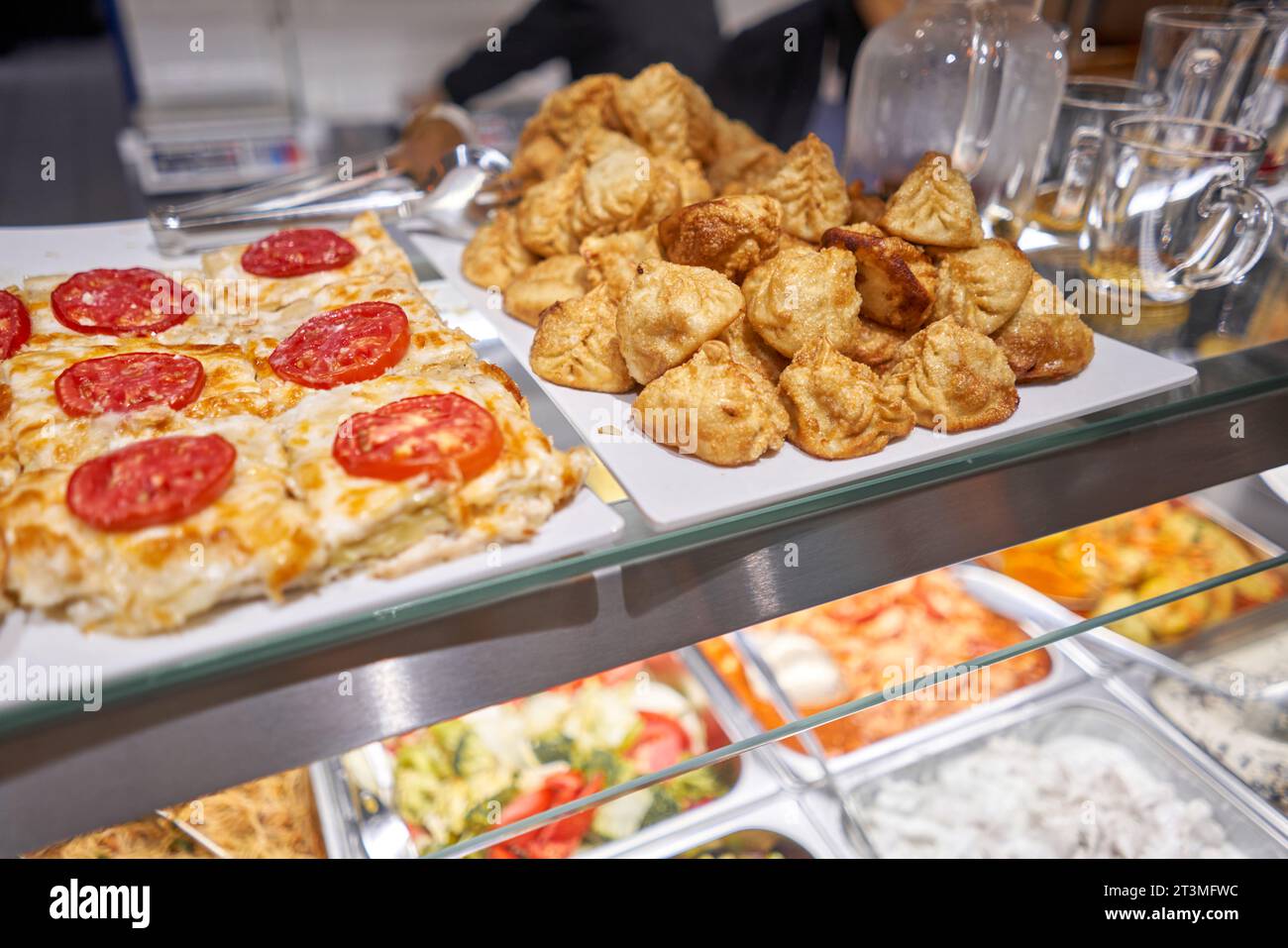 Various hot dishes . Glass Showcase in a buffet or self-service ...