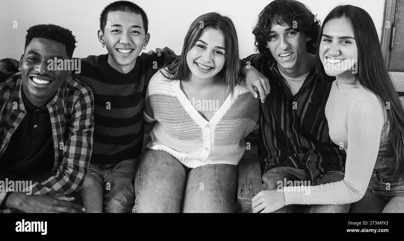 Portrait of happy multiracial teenagers studying together at school ...