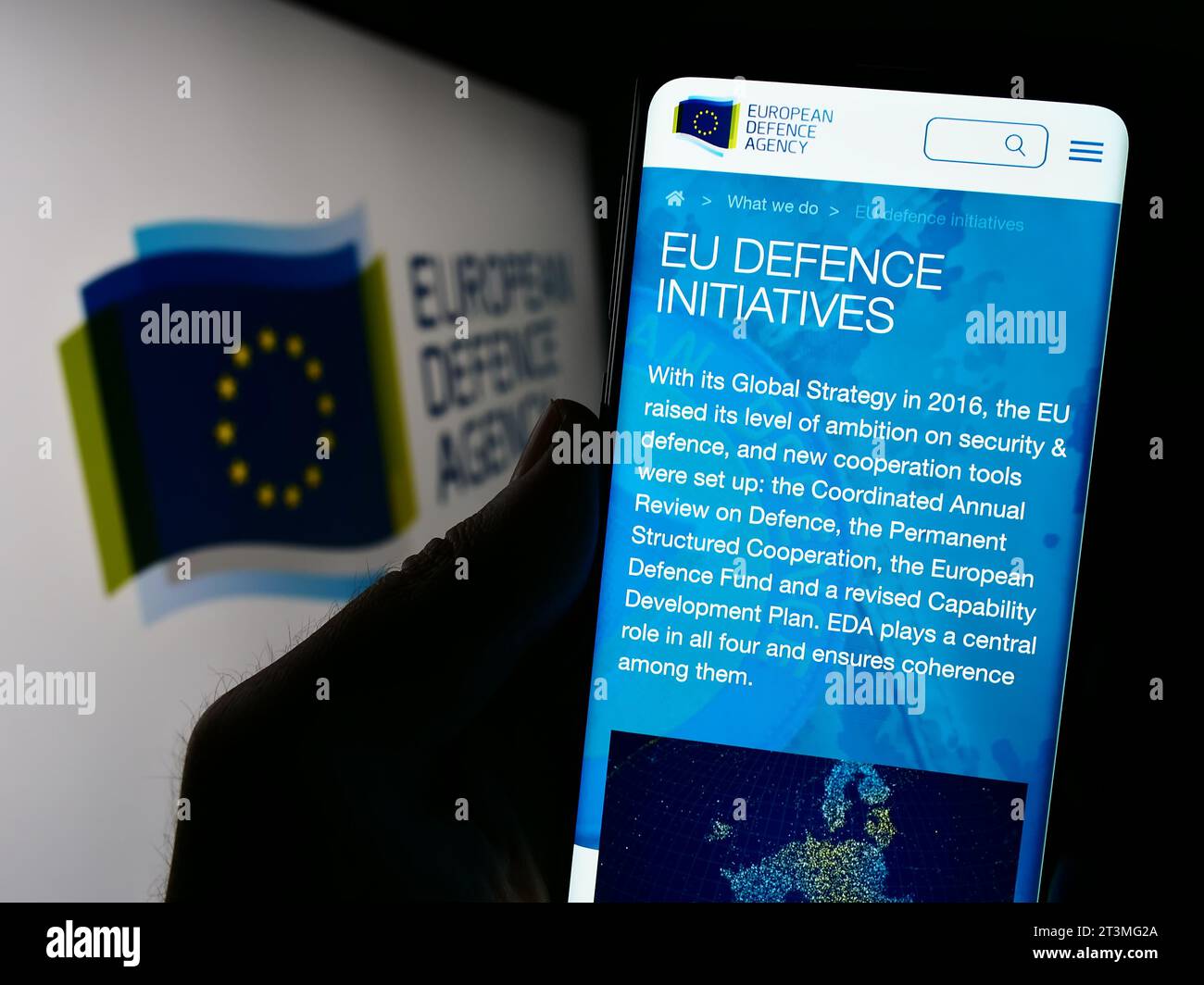 Person holding cellphone with webpage of EU institution European ...