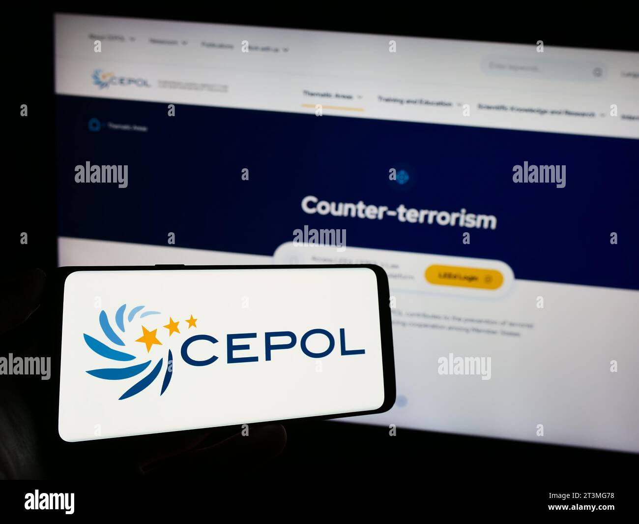 Person holding mobile phone with logo of European Union Agency for Law ...