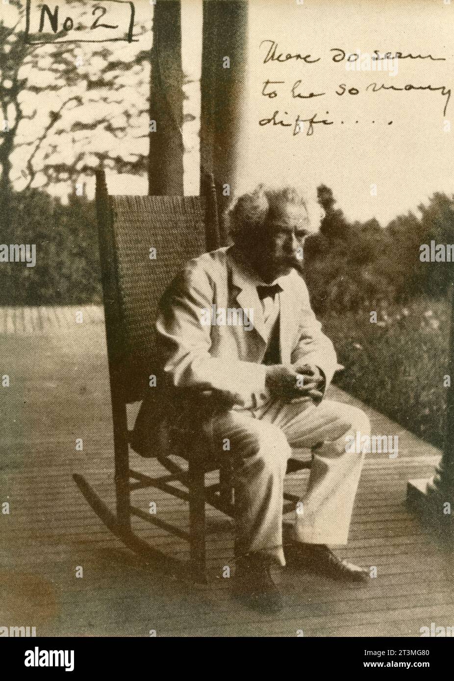 American writer Mark Twain sitting in a chair in the porch, USA 1900s ...