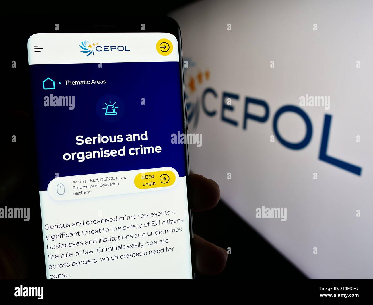 Person holding cellphone with webpage of European Union Agency for Law ...