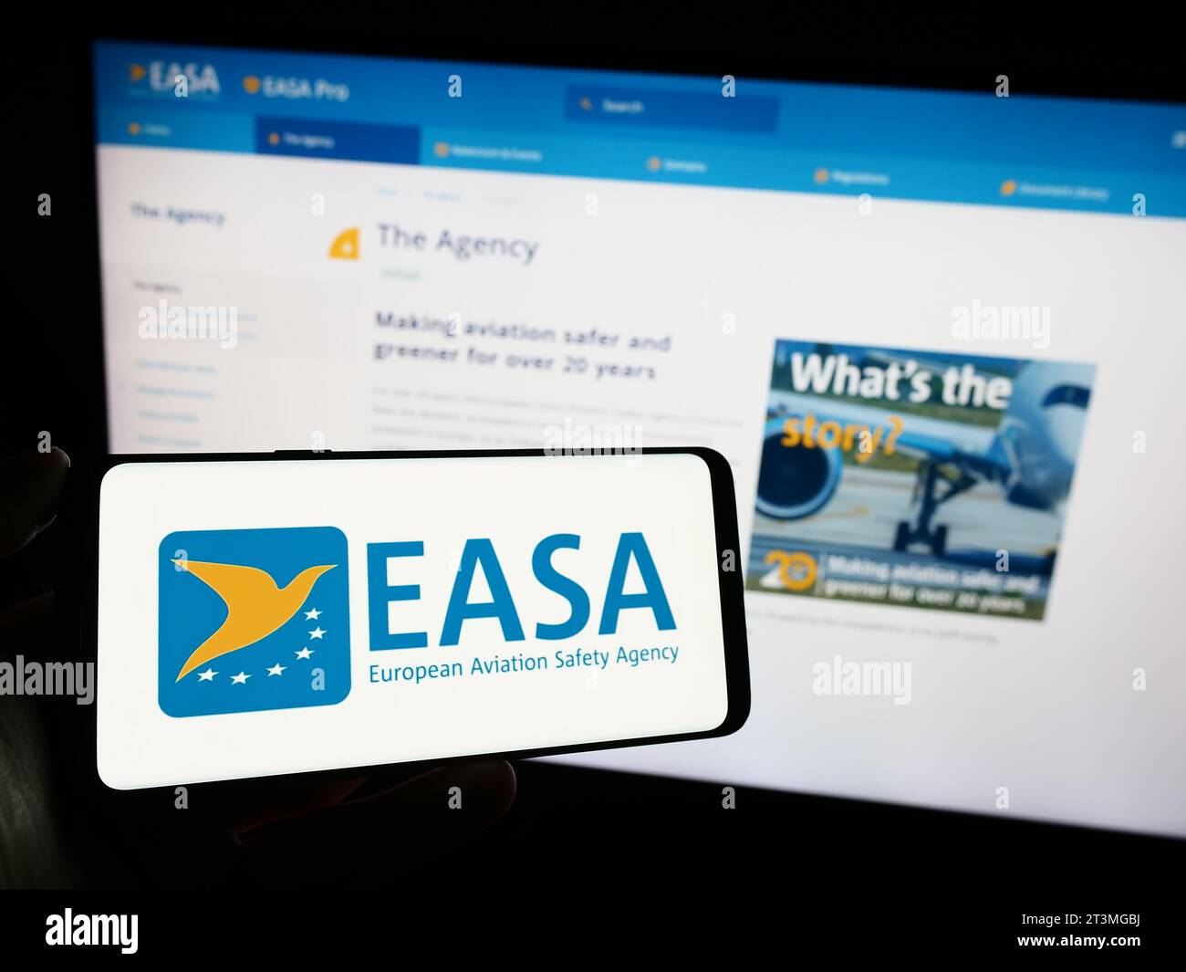 Person holding mobile phone with logo of European Union Aviation Safety ...