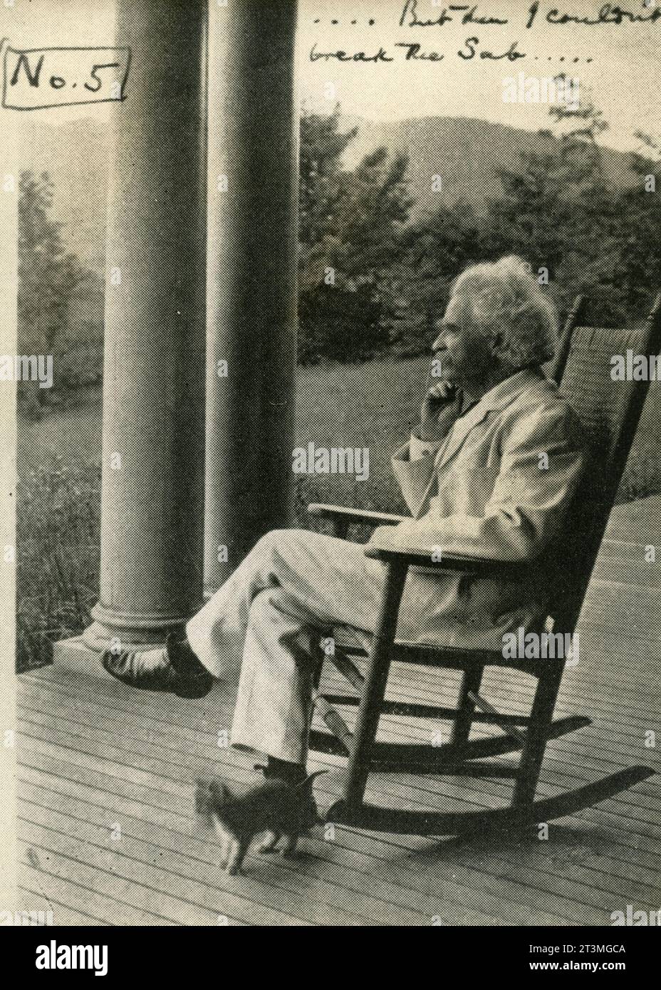 American writer Mark Twain sitting in a chair in the porch, USA 1900s ...