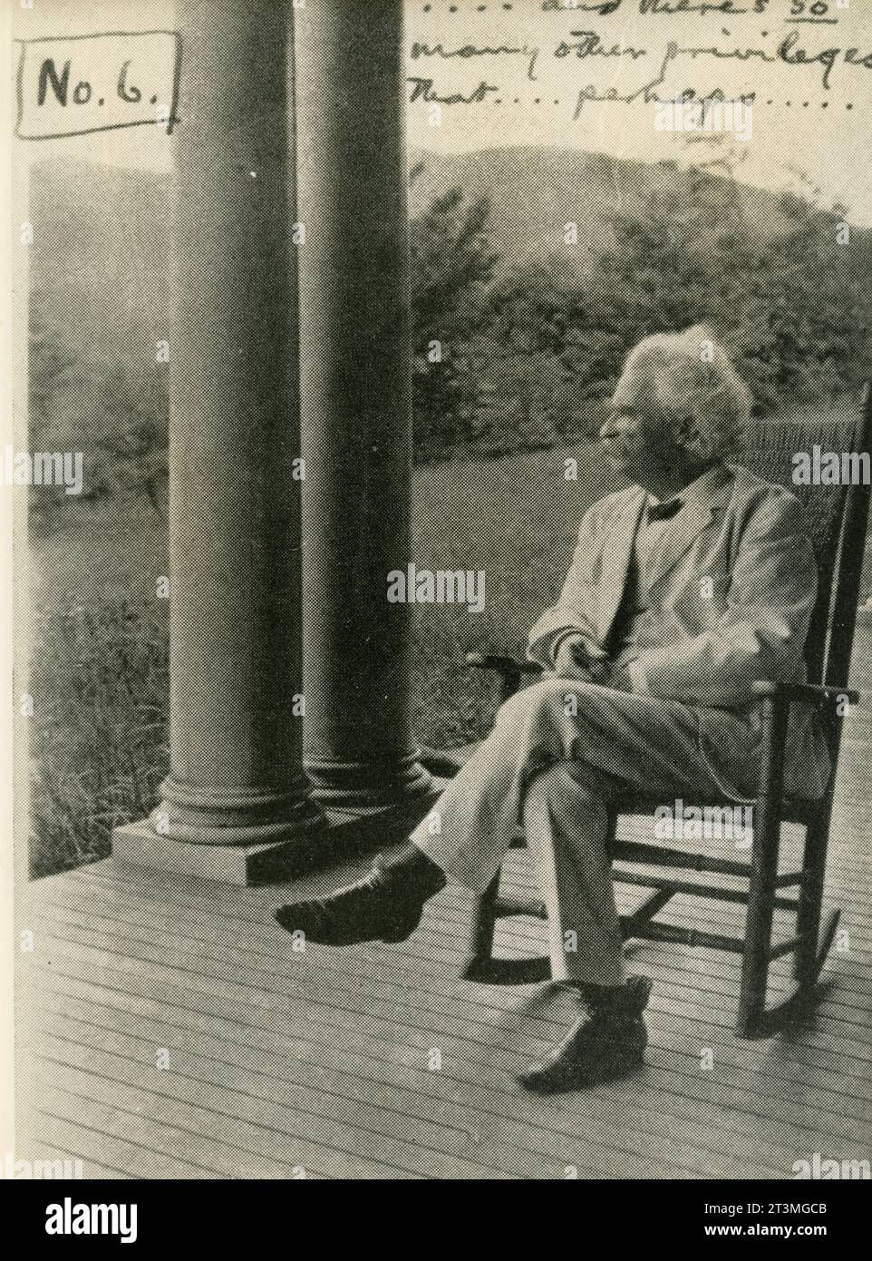 American writer Mark Twain sitting in a chair in the porch, USA 1900s ...