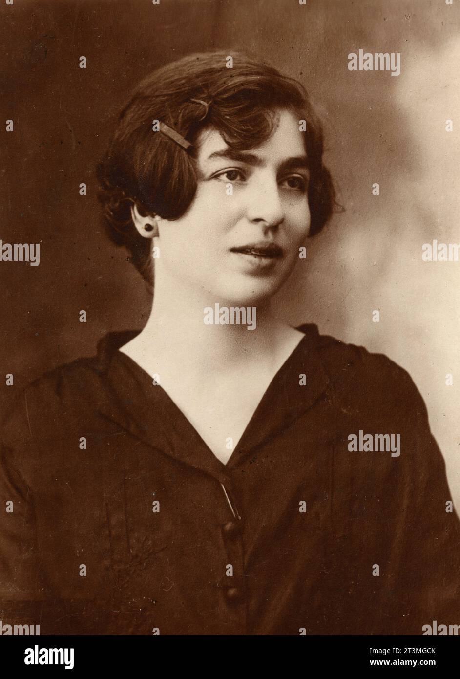 Studio portrait close-up of a young woman with short brown hair and ...