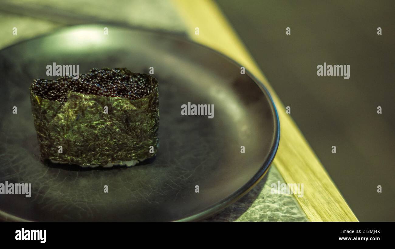 Sushi is a typical japanese food containing rice wrapped in seaweed and ...