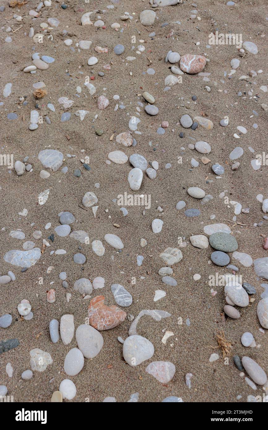 Abstract background beach sand with pebble rocks on the ground at ...