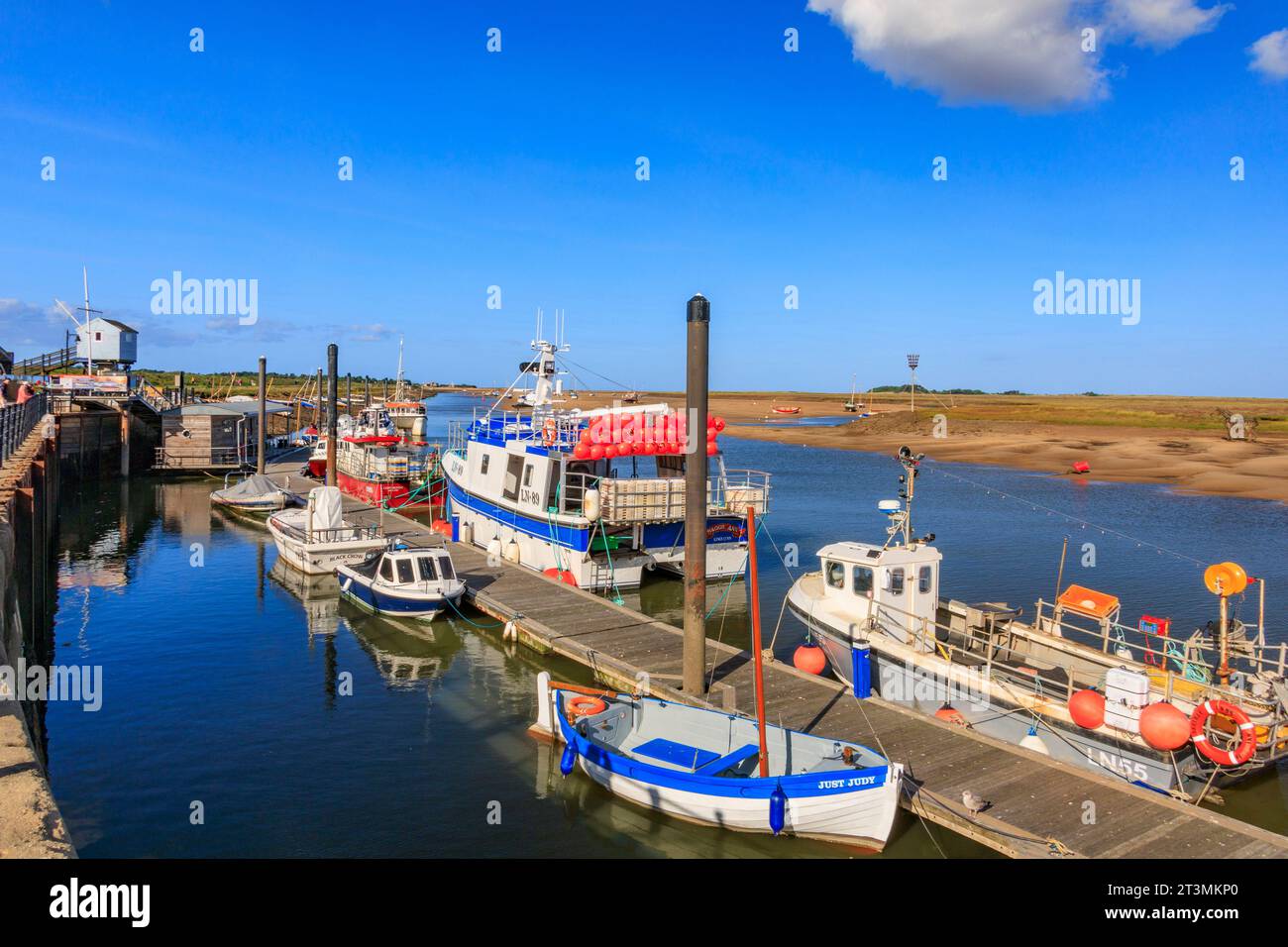 A mixture of colourful leisure and fishing boats berthed alongside the ...