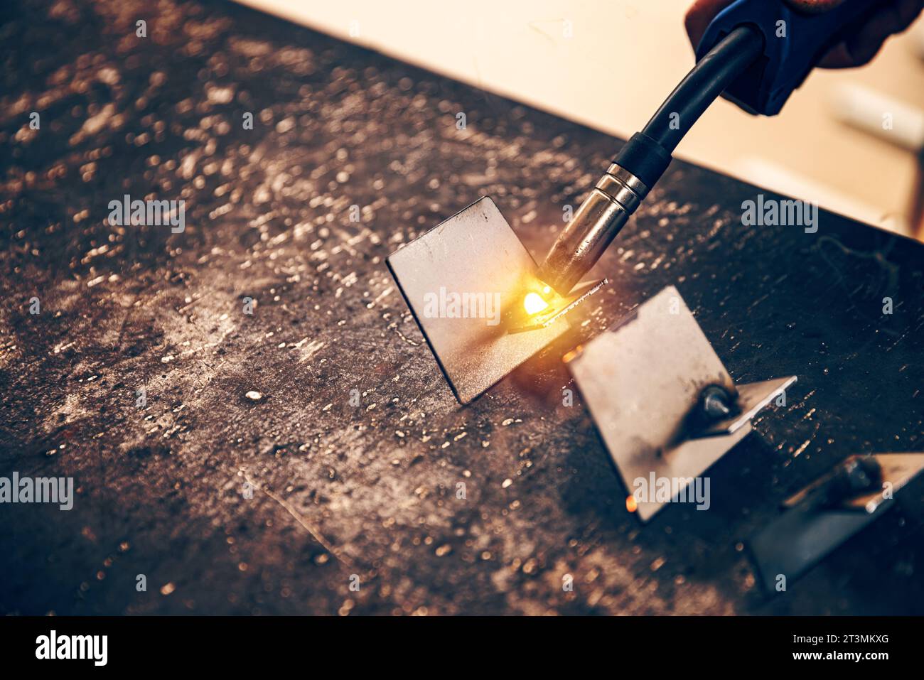TIG welder is holding welding torch of a welding machine and welding ... TIG welder is holding welding torch of a welding machine and welding ...