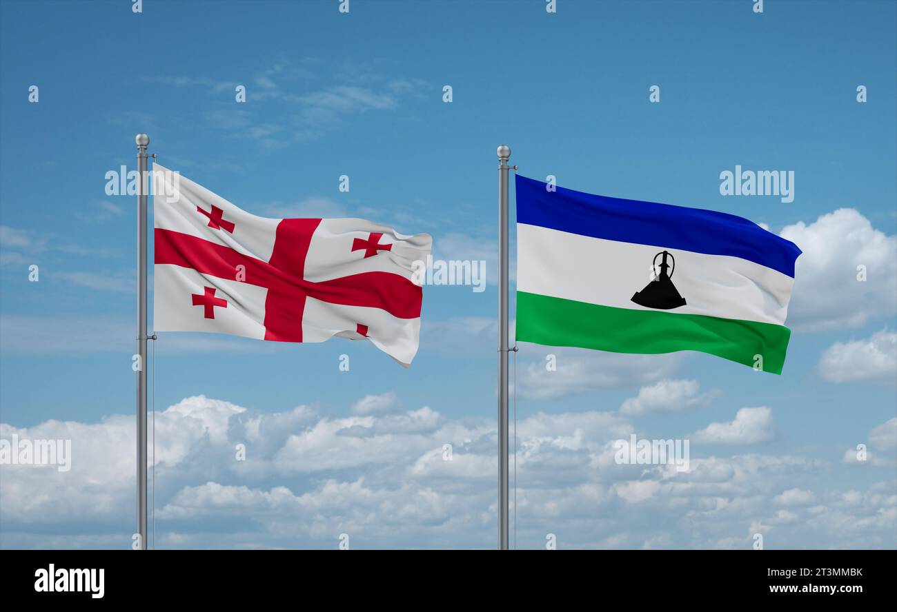 Lesotho and Georgia flags waving together in the wind on blue cloudy ...