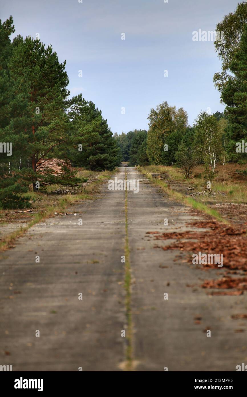 View over a long and empty concrete road Stock Photo - Alamy