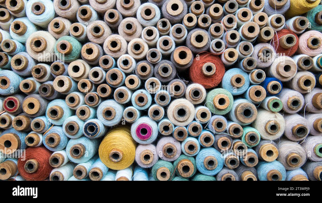 Spools of thread of different sizes and colours in a sewing shop Stock ...