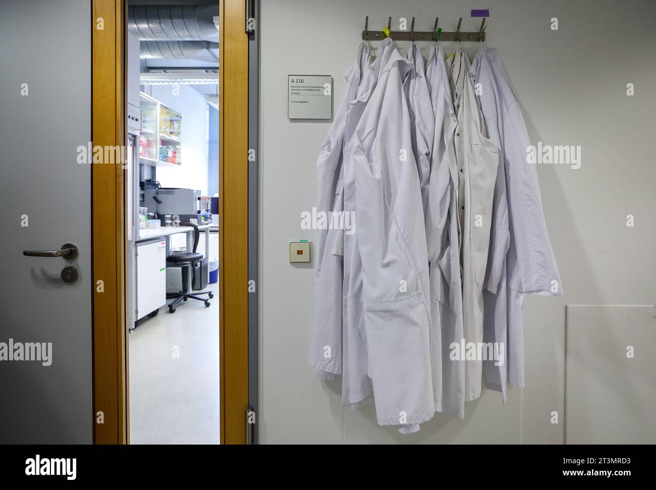 26 October 2023, Saxony, Leipzig: Gowns hang next to a lab at the ...
